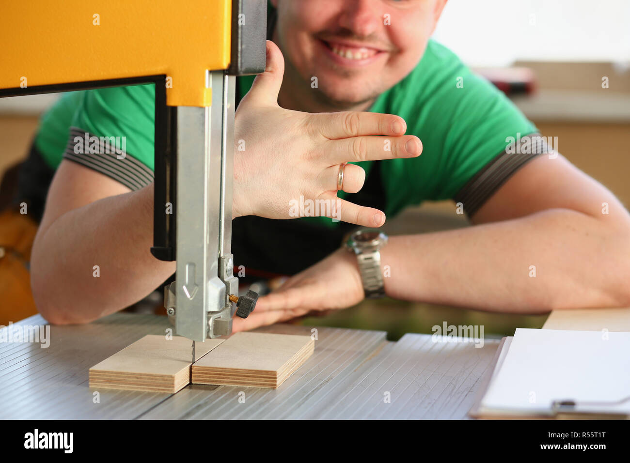 Happy smiling worker wearing yellow hard hat Stock Photo - Alamy