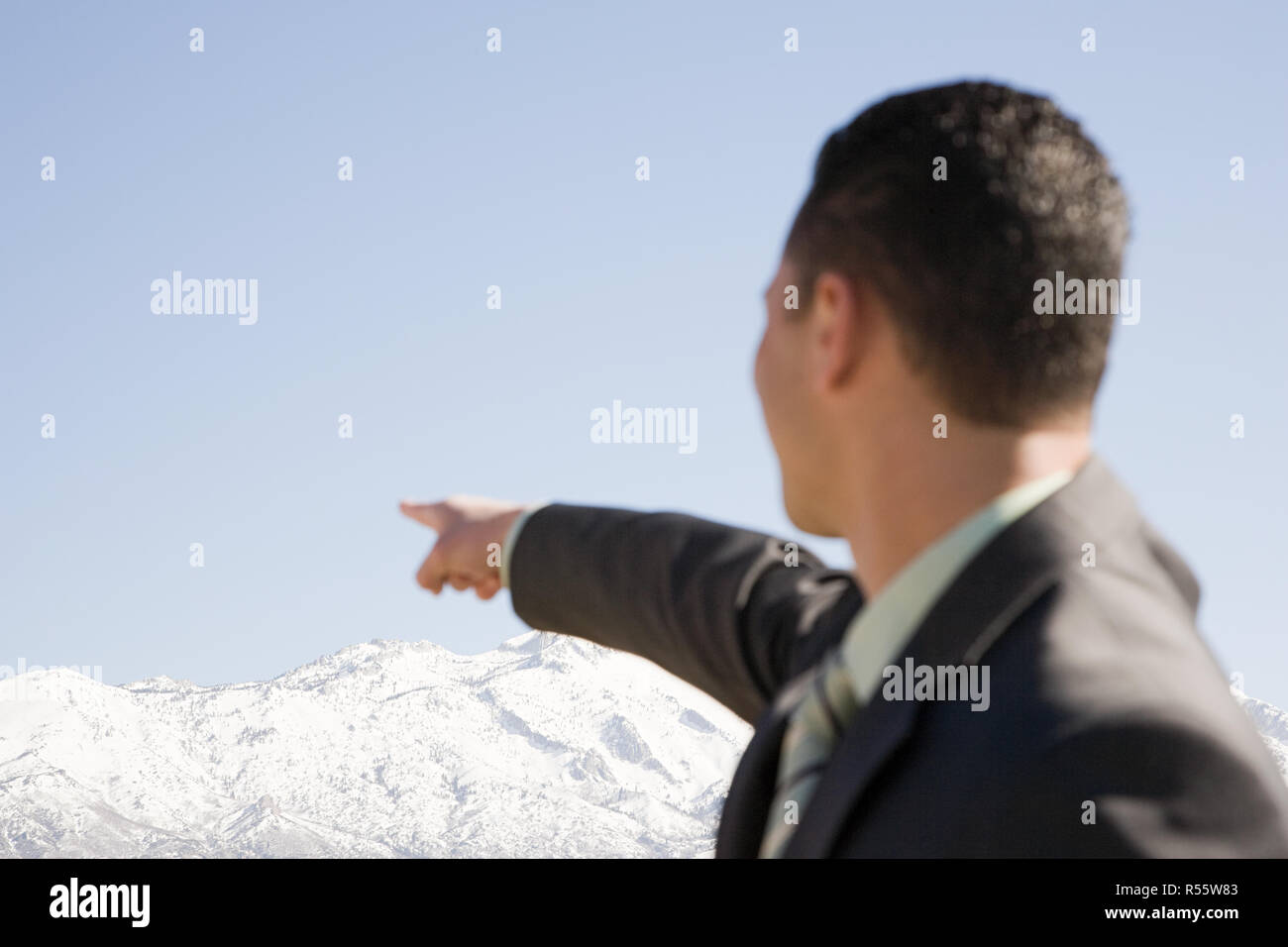 Man pointing at mountains Stock Photo - Alamy