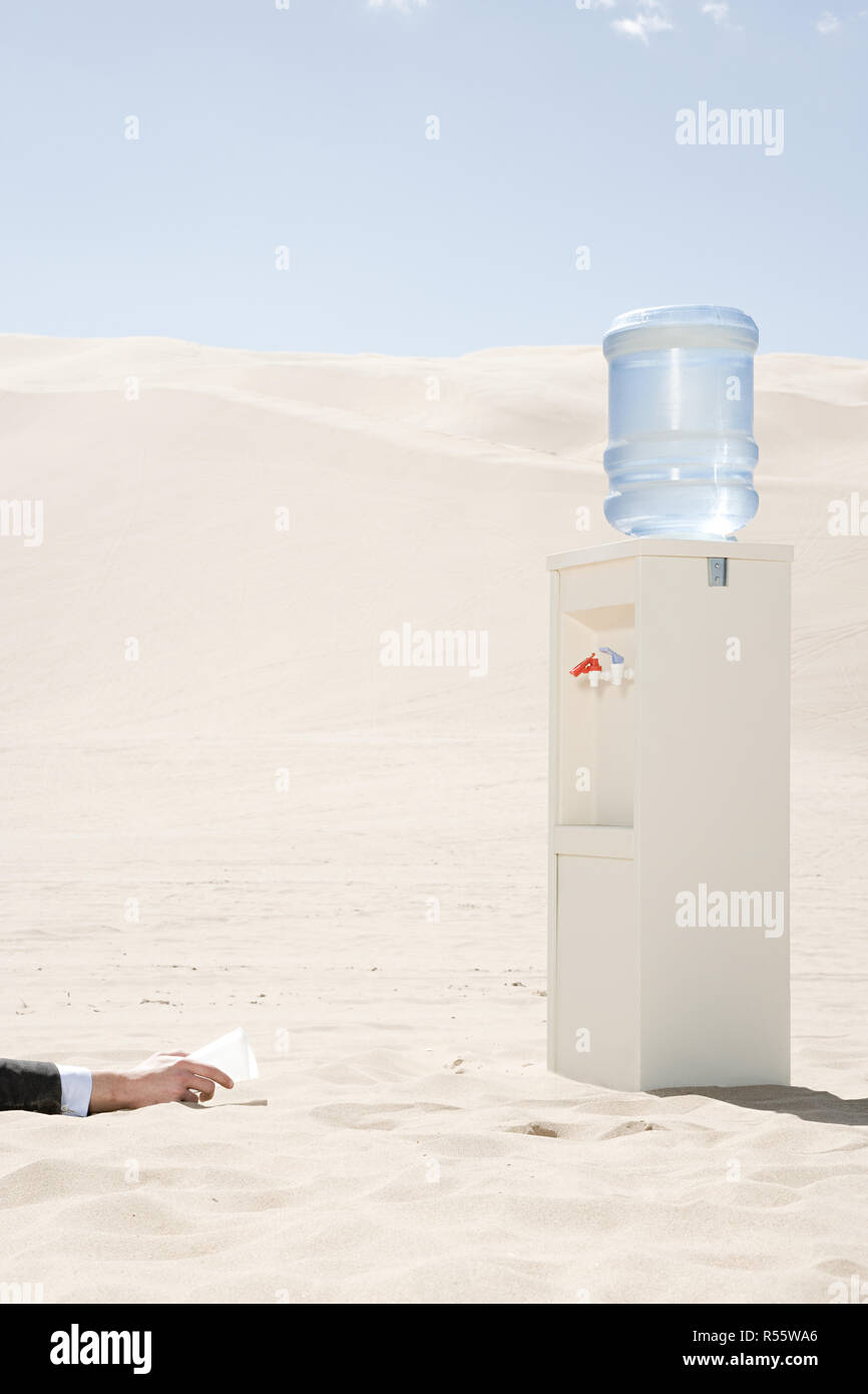 Person reaching for water cooler in desert Stock Photo - Alamy