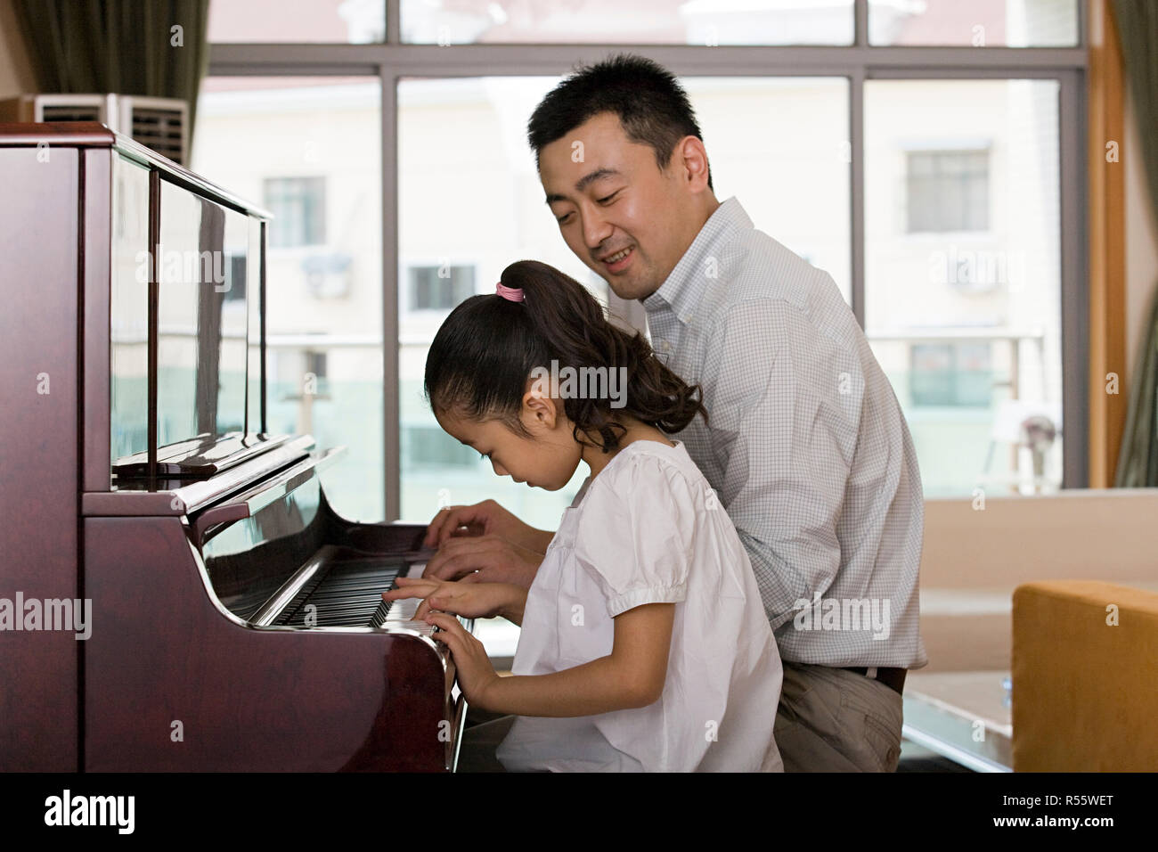 Father and daughter playing the piano Stock Photo - Alamy