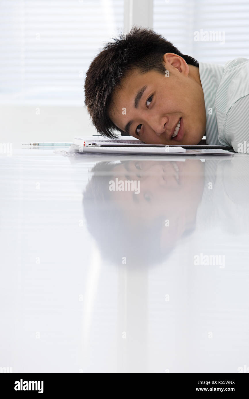 Man leaning on desk Stock Photo - Alamy