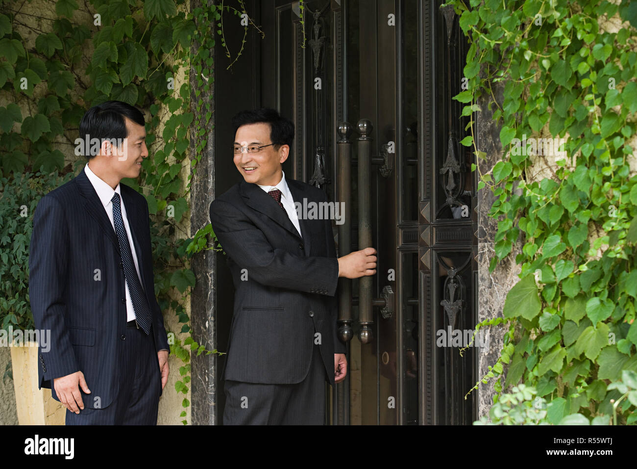 Chinese businessmen outside a house Stock Photo - Alamy