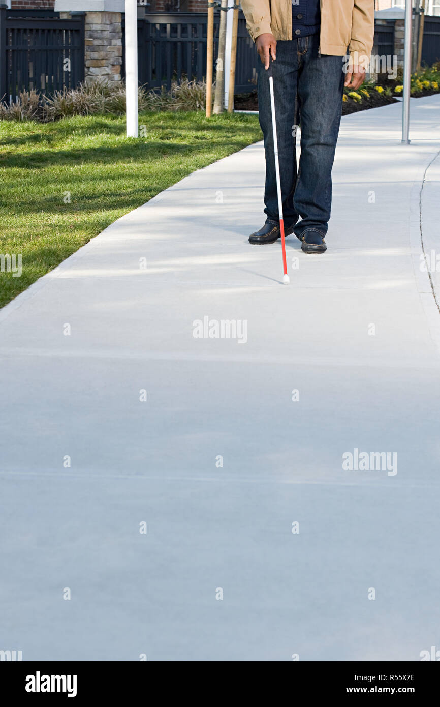 Blind man walking with a stick Stock Photo - Alamy