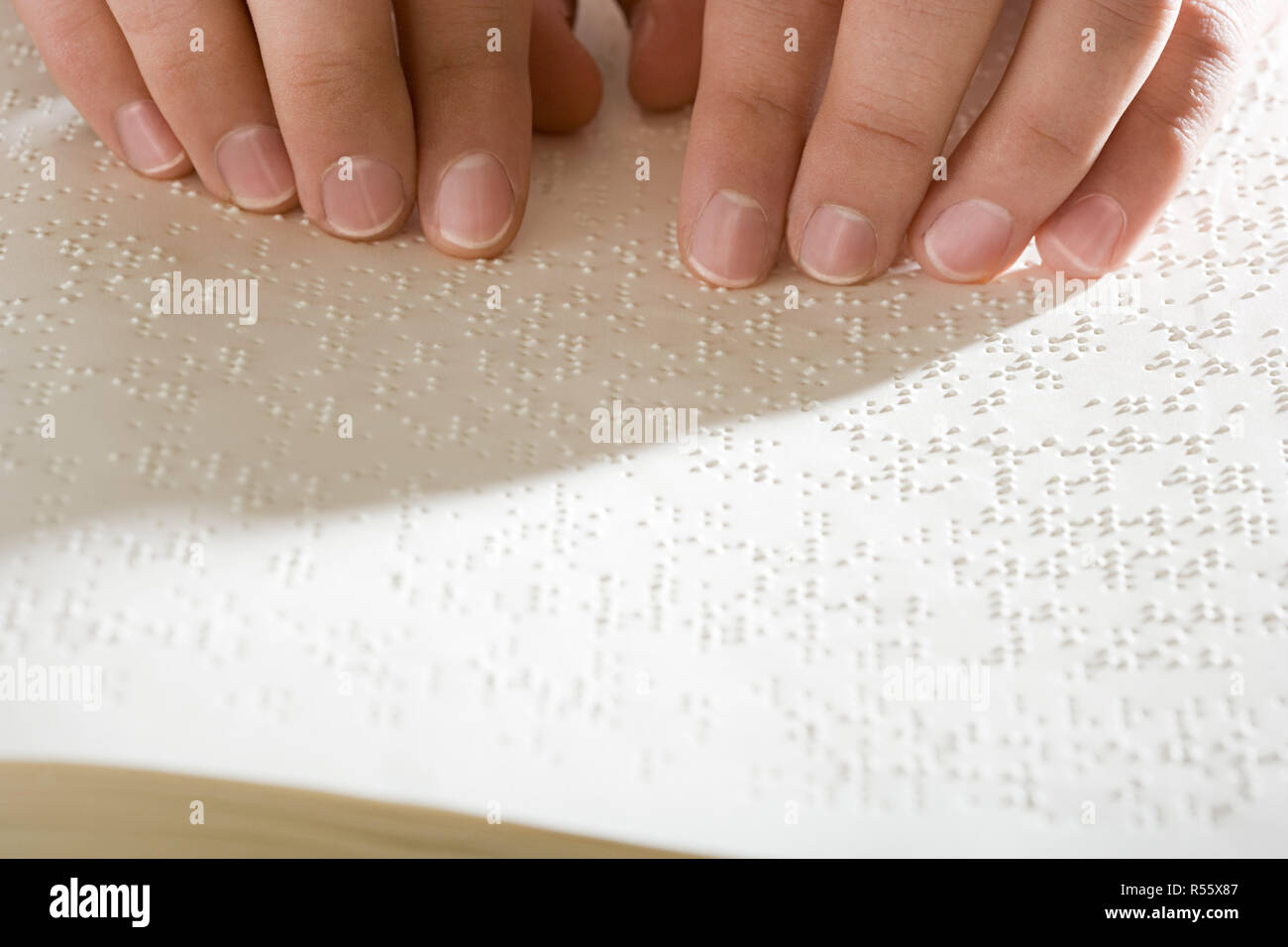 One woman reading braille Stock Photo - Alamy