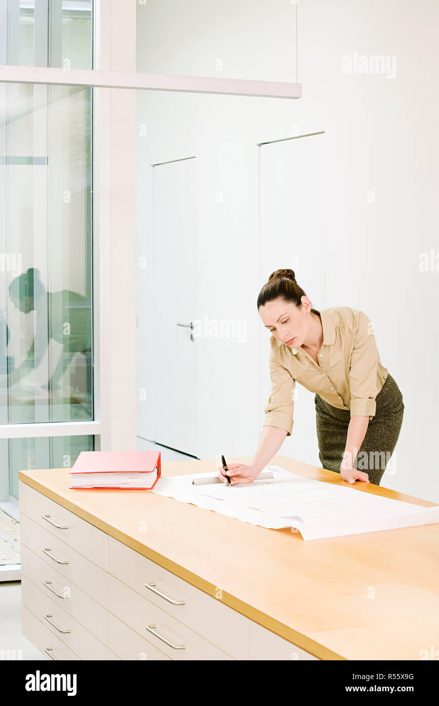 Female architect drawing Stock Photo - Alamy
