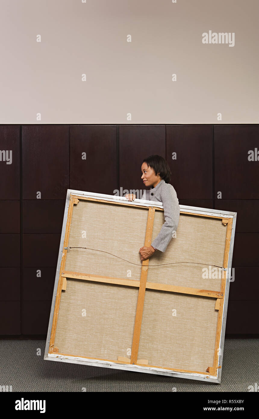 Person carrying picture frame hi-res stock photography and images - Alamy