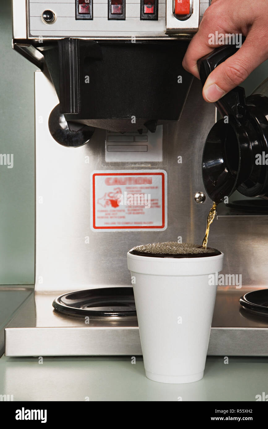 Businessman pouring a coffee Stock Photo - Alamy