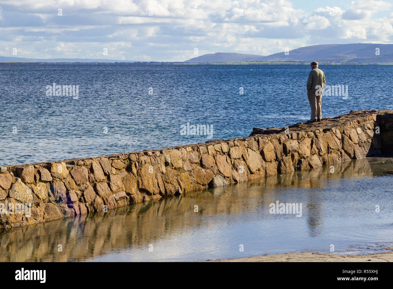Old man looking to the ocean in Blackrock Beach, Salthill, Galway ...
