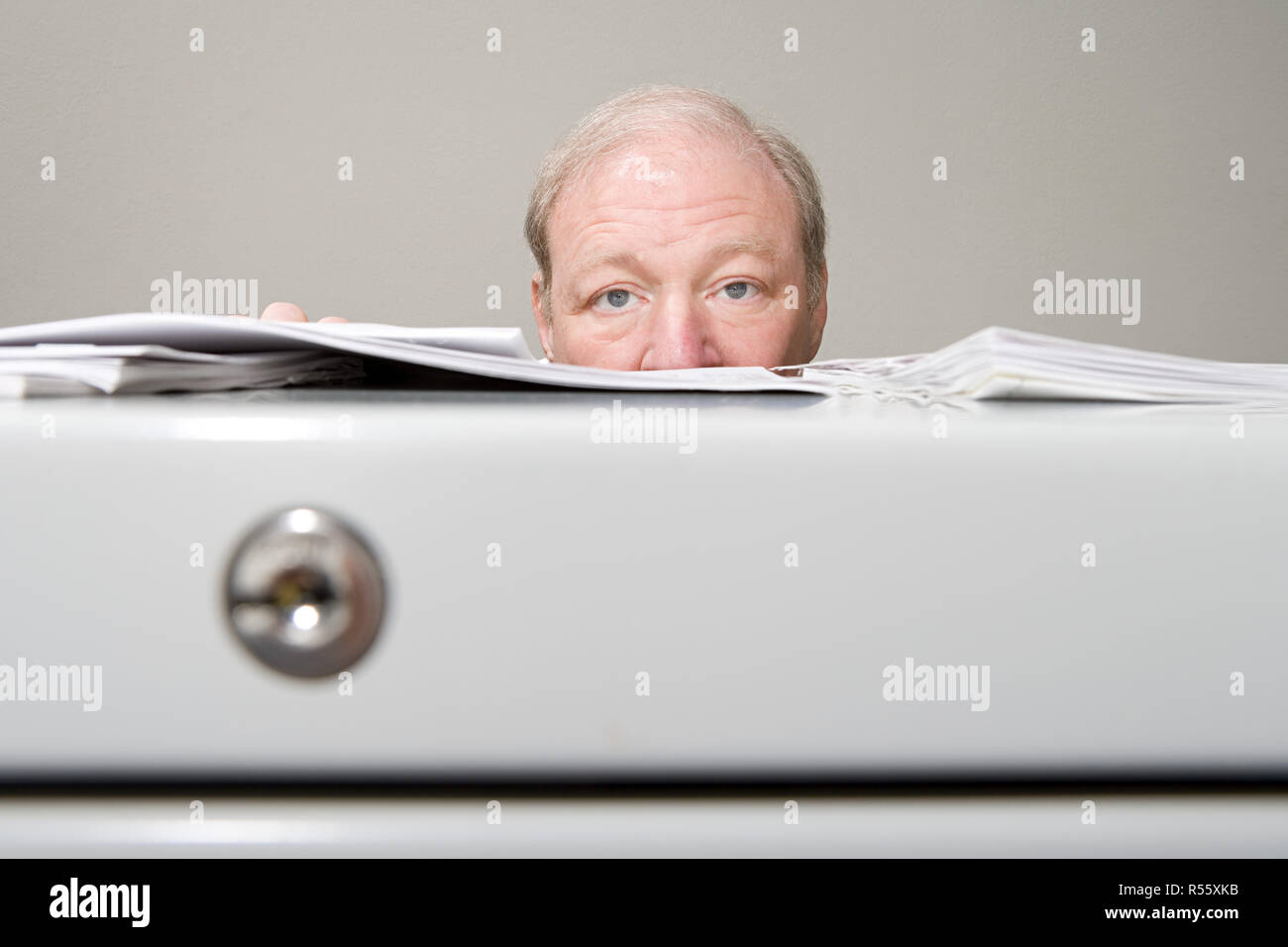 Man behind filing cabinet Stock Photo - Alamy