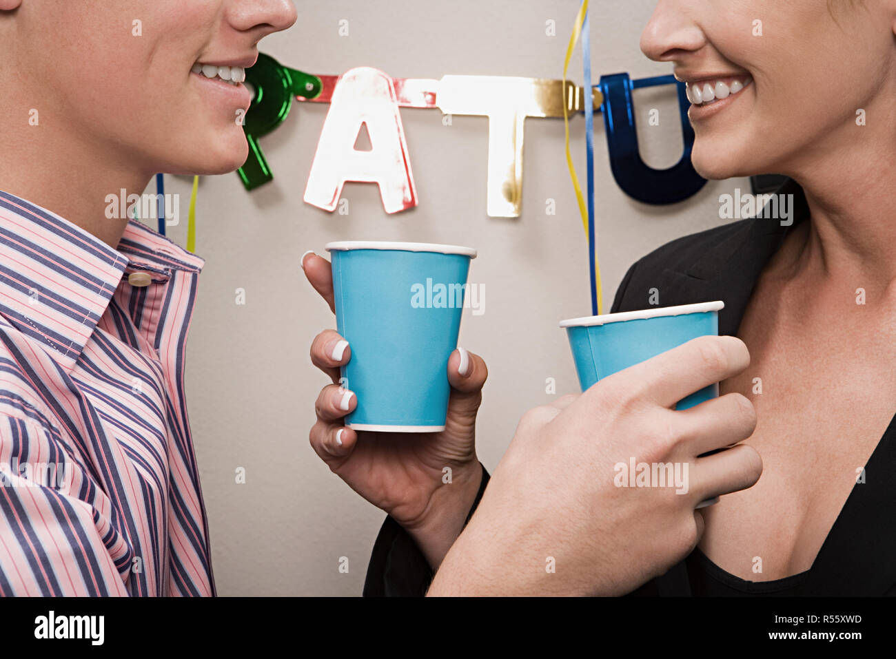 Two office workers toasting Stock Photo - Alamy
