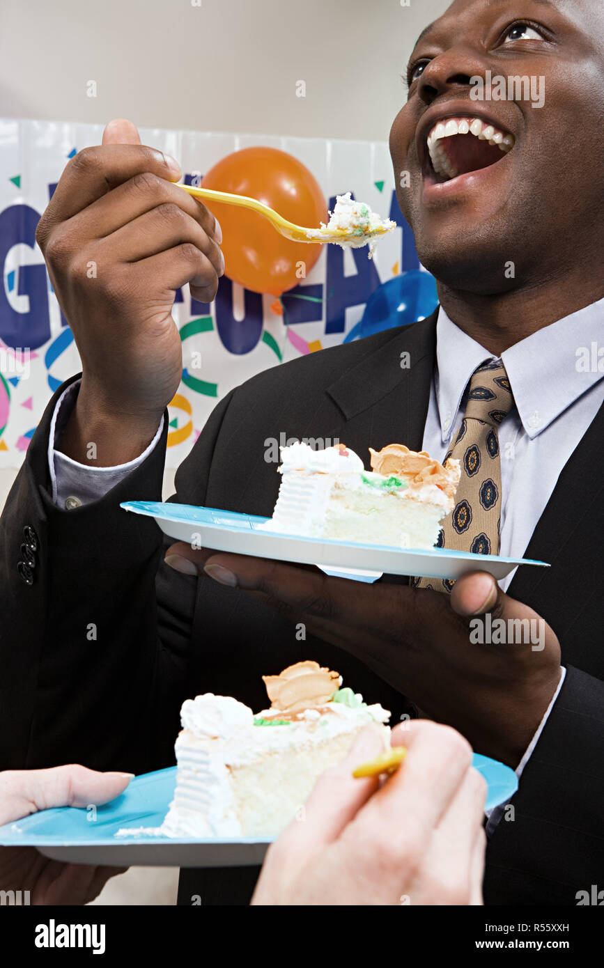 Office workers eating party cake Stock Photo - Alamy