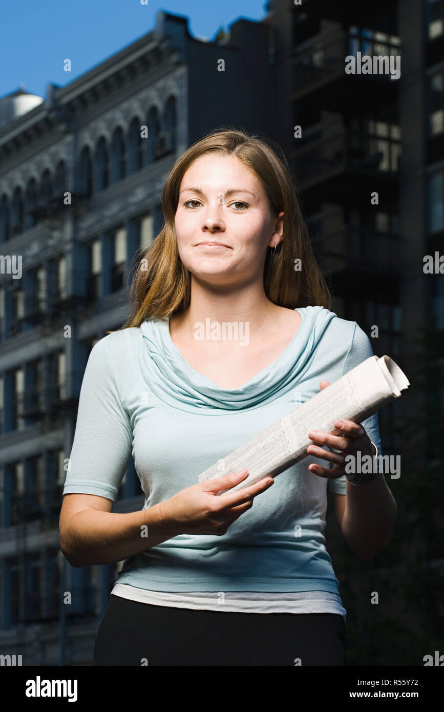 Woman holding newspaper Stock Photo - Alamy