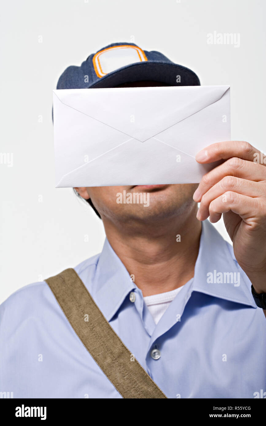 Postman holding a letter Stock Photo - Alamy