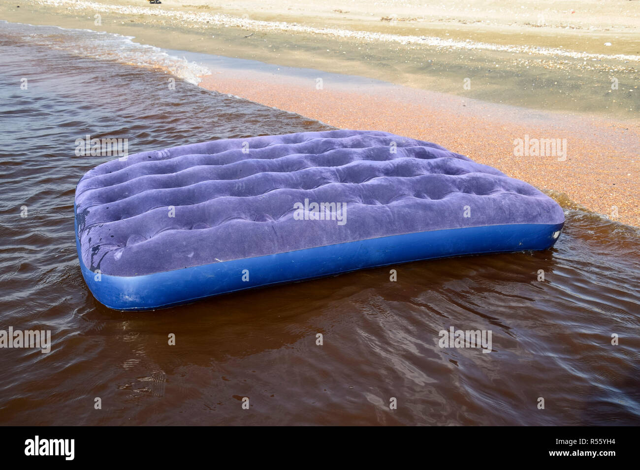 Blue inflatable mattress swimming in the pond Stock Photo - Alamy