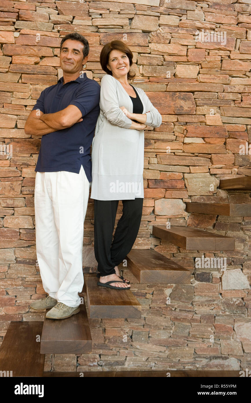 Couple standing on steps Stock Photo - Alamy