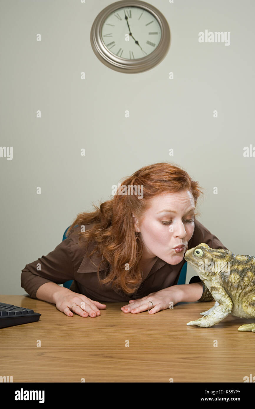 Woman kissing frog Stock Photo - Alamy