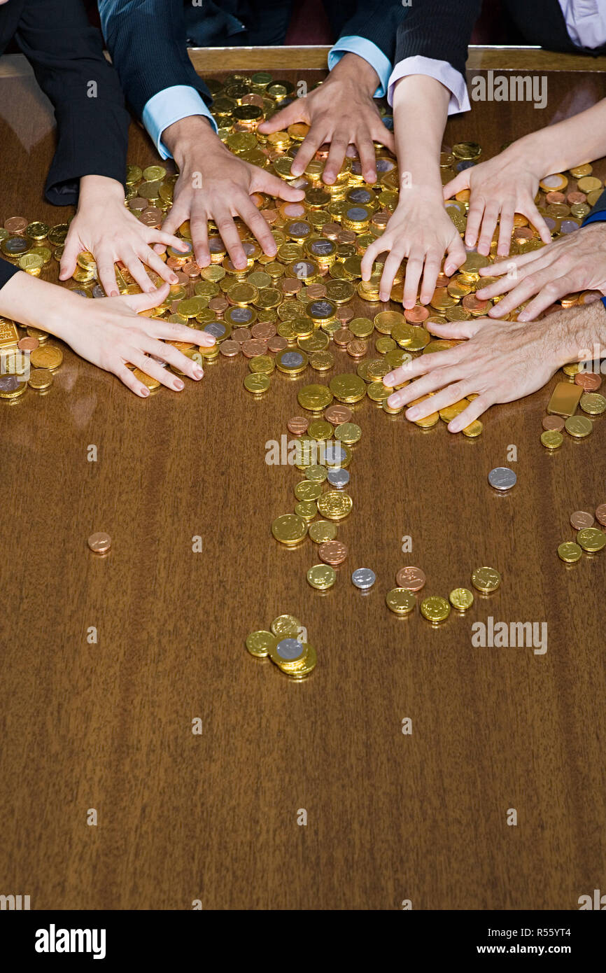 Hands grabbing coins Stock Photo - Alamy