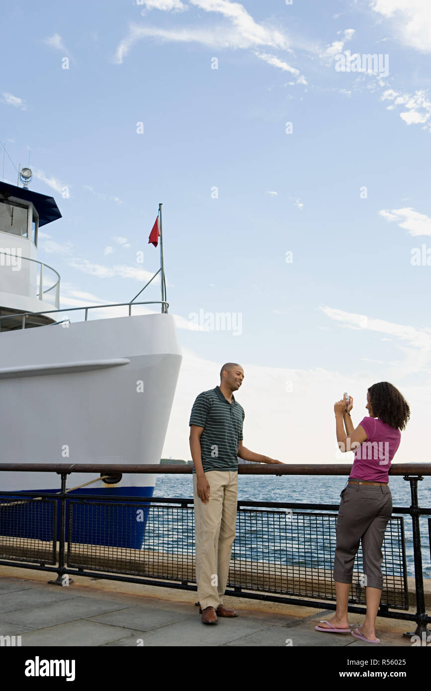 Woman photographing man Stock Photo - Alamy