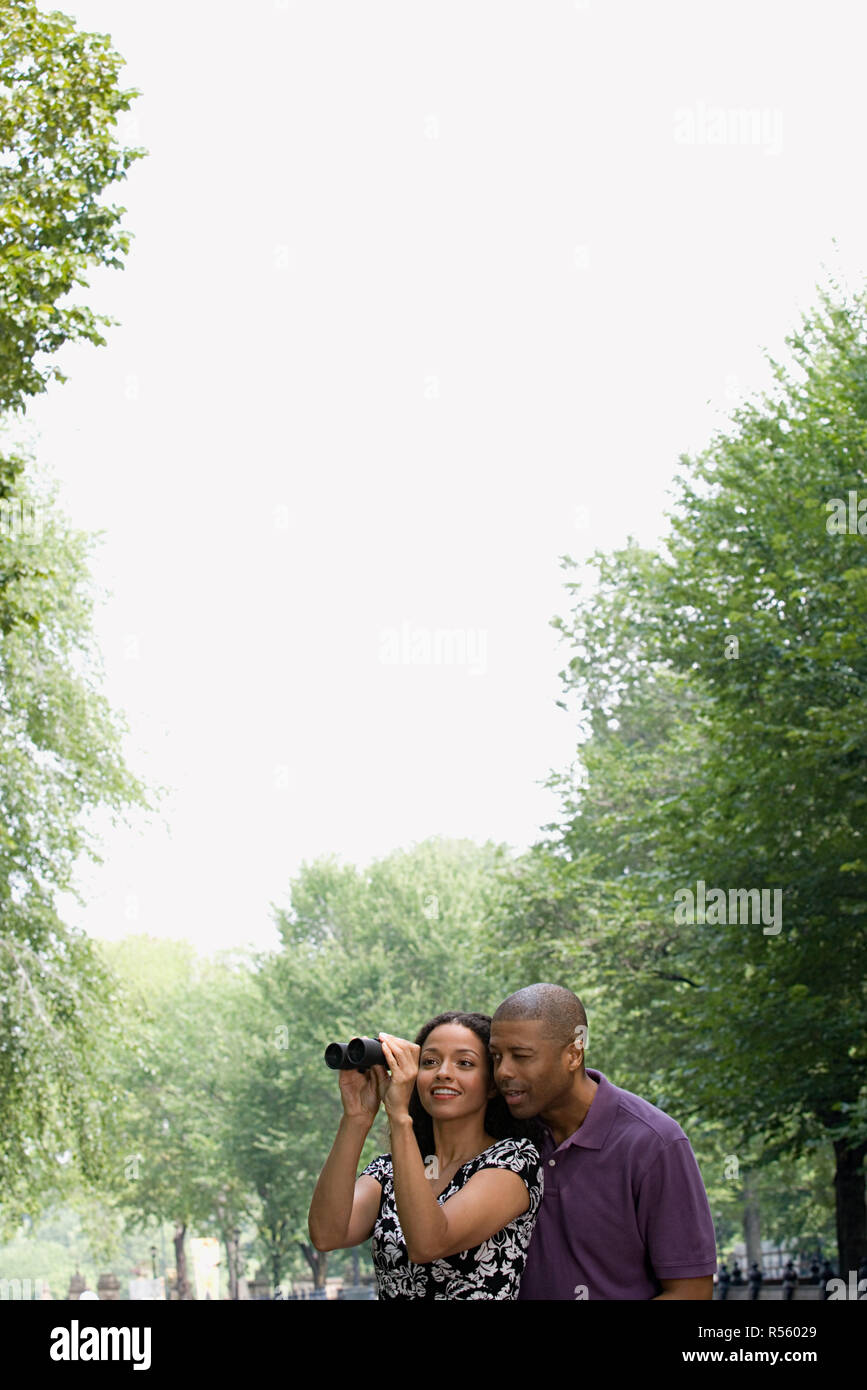 Two people looking through telescope hi-res stock photography and ...