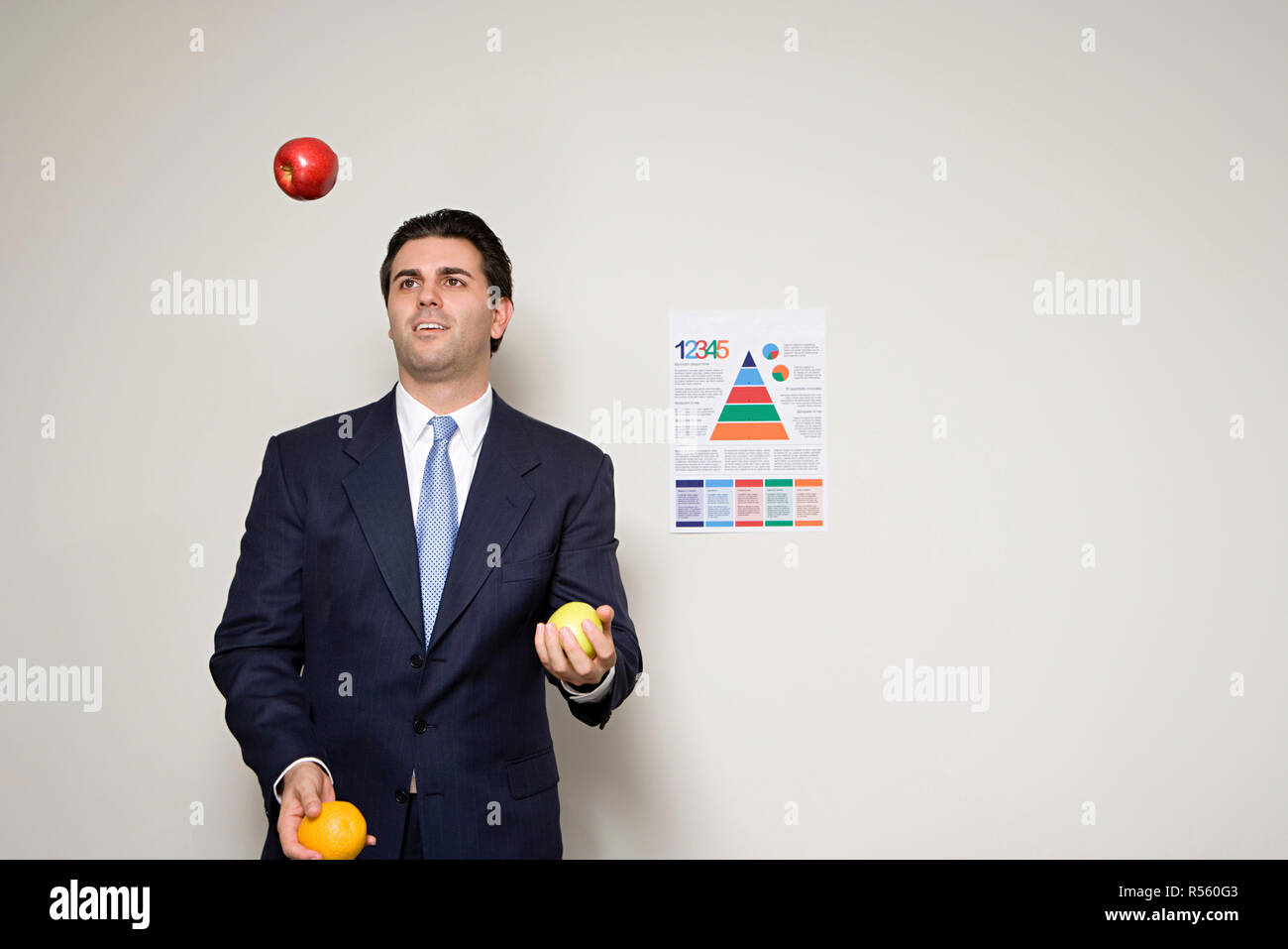 Businessman juggling fruit Stock Photo - Alamy