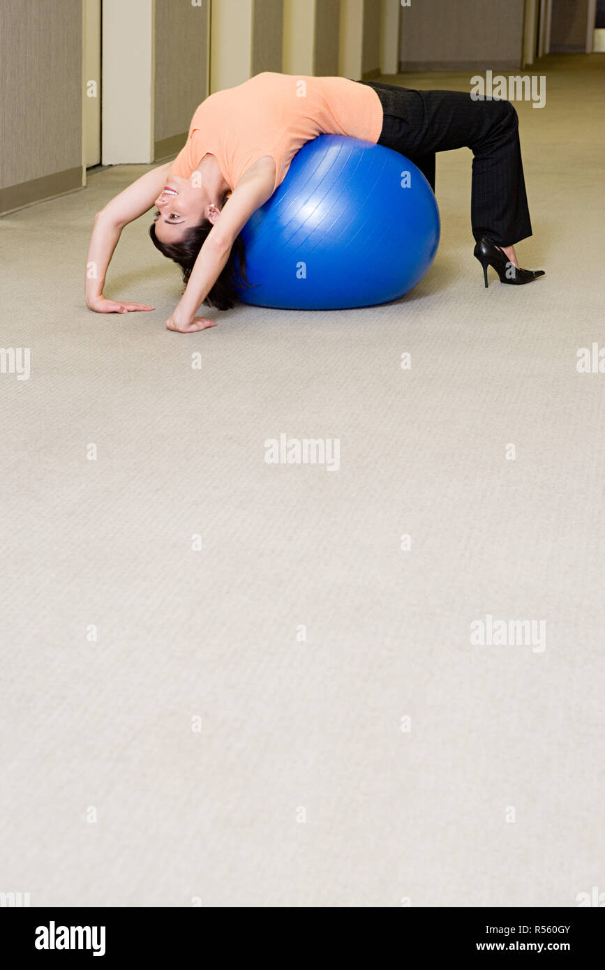 Female office worker using an exercise ball Stock Photo - Alamy