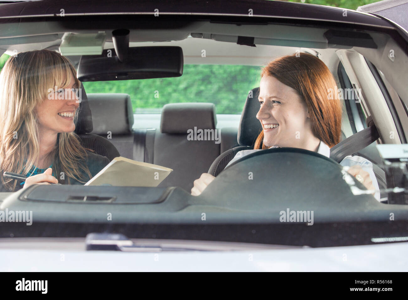 Teenager in car with driving instructor Stock Photo - Alamy