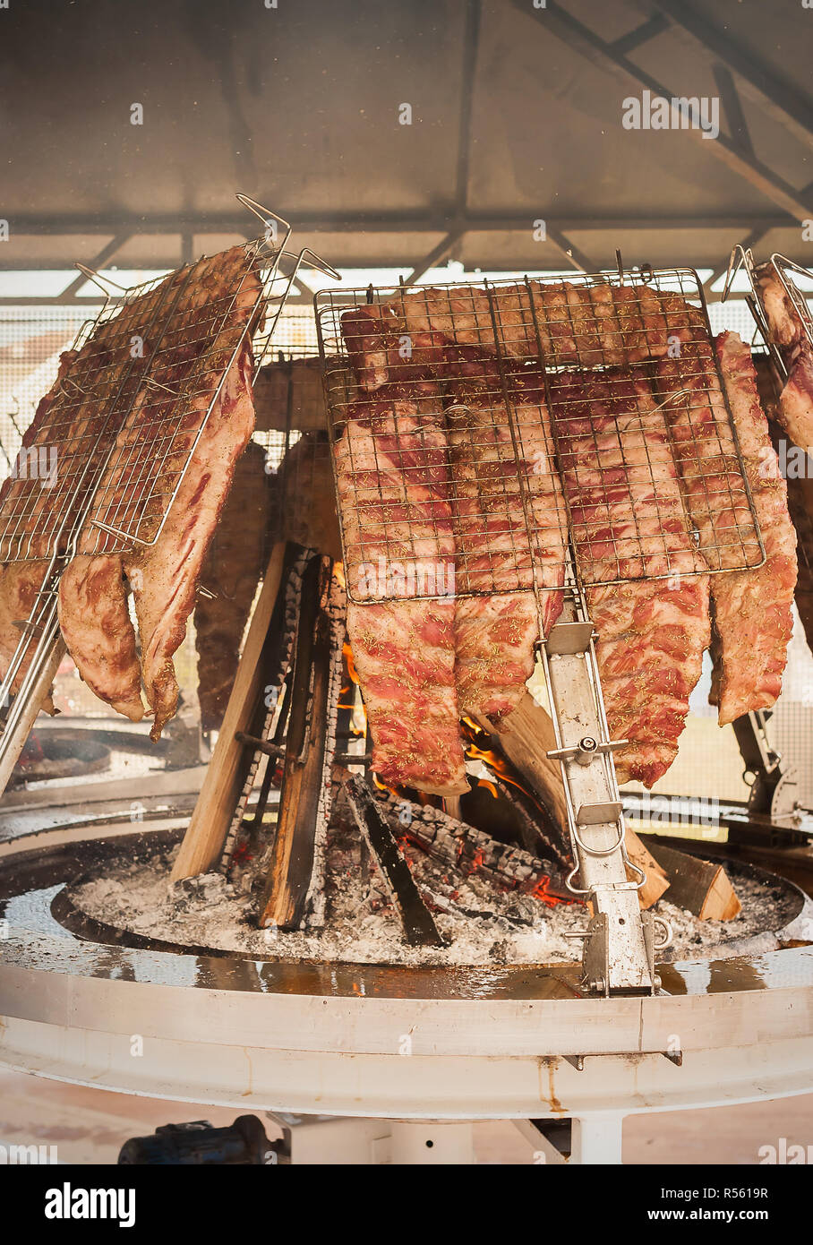 Roasted meat of beef cooked on a vertical grills Stock Photo - Alamy
