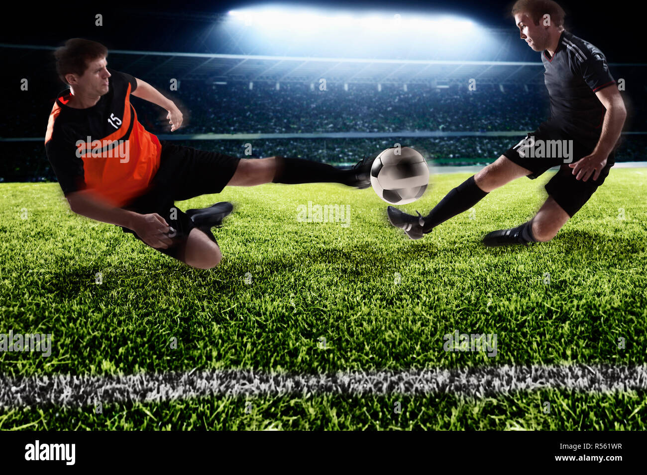 Two soccer players kicking a soccer ball Stock Photo - Alamy