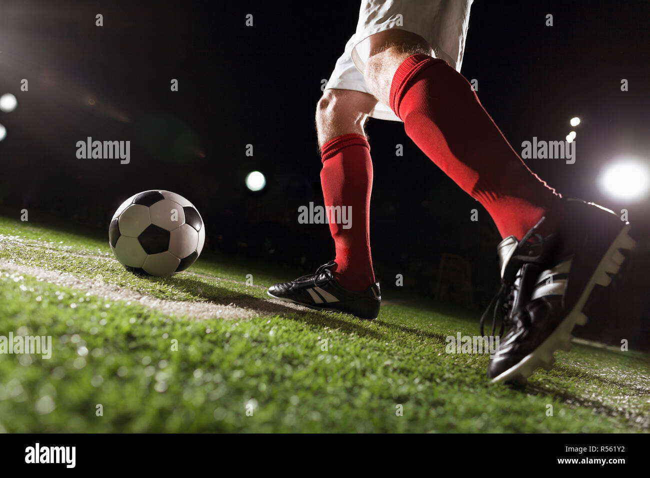 Soccer player making a corner kick Stock Photo - Alamy