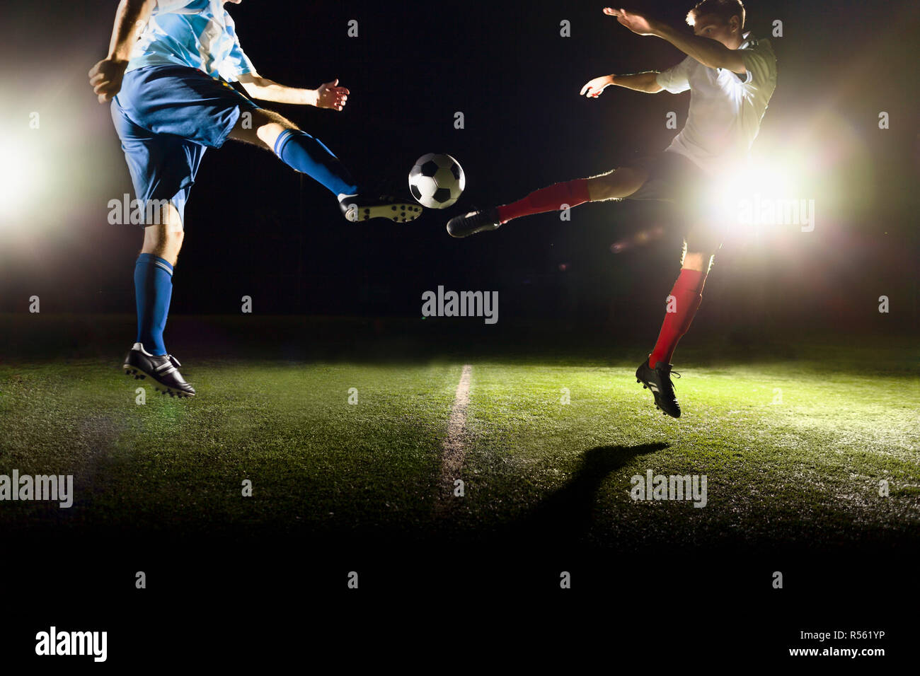 Two soccer players kicking a soccer ball Stock Photo - Alamy