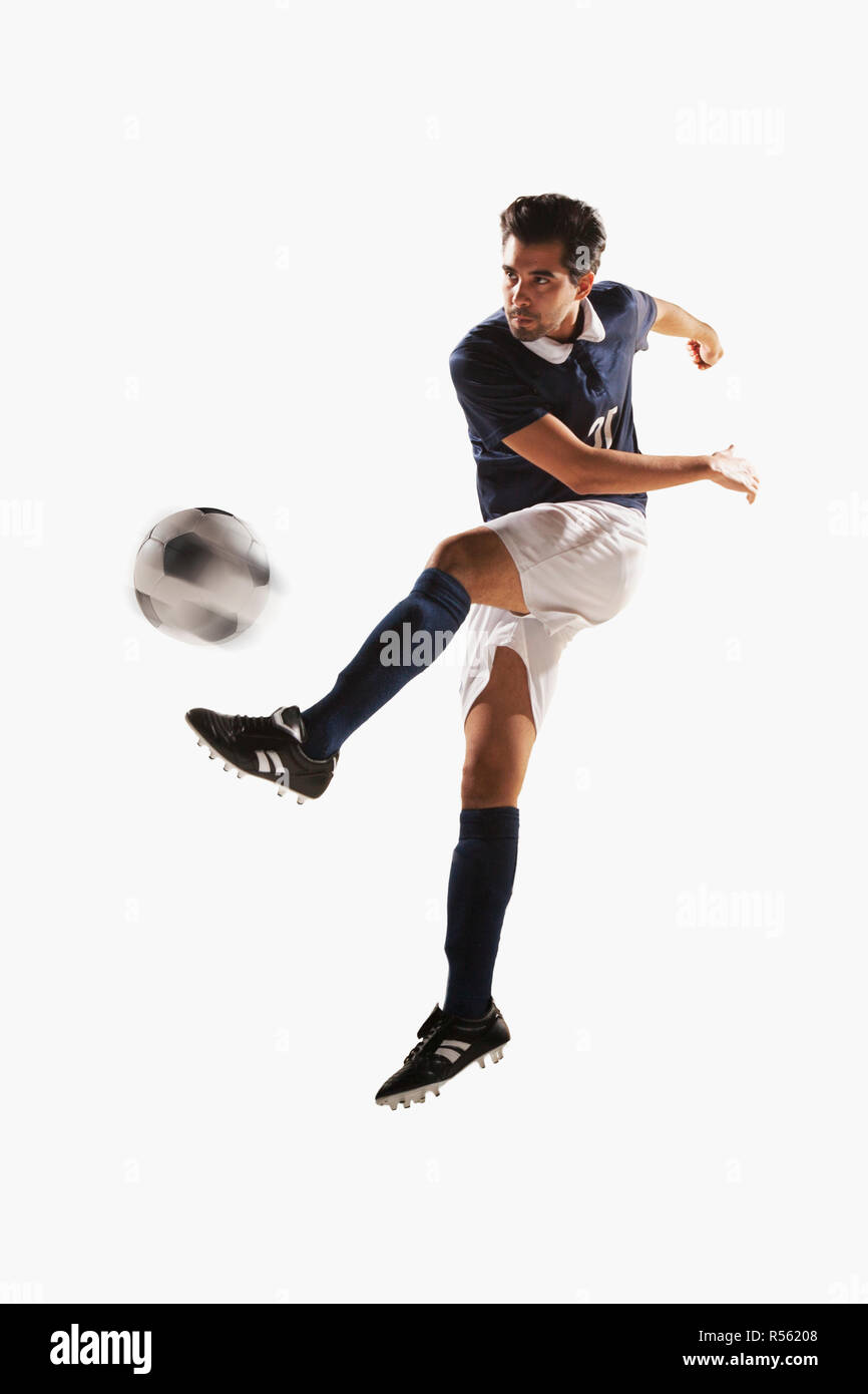 Soccer player kicking soccer ball Stock Photo - Alamy