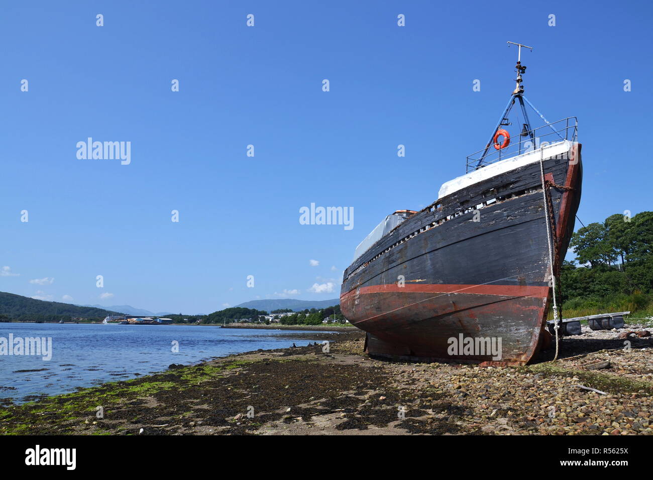 Abandoned vintage fishing boat on beach near Corpach village, Fort ...