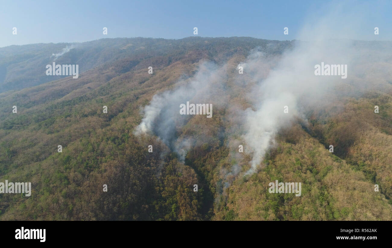 aerial view forest fire smoke on the slopes hills. wild fire in ...
