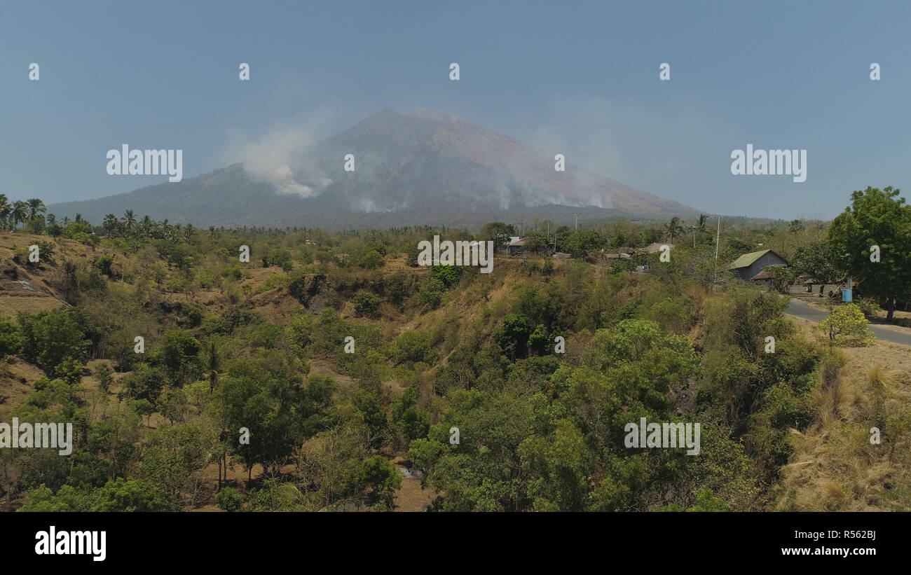slopes volcano with forest fire, farmland at foot of the volcano Agung ...