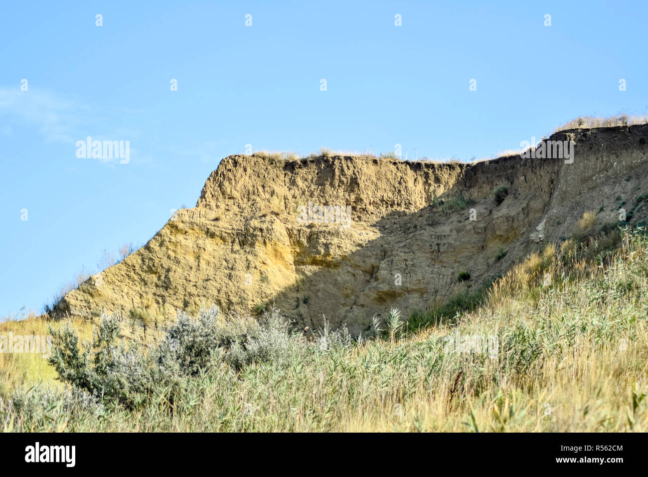 Breakage of the rock. The layers of clay and soil are visible. Clayey ...