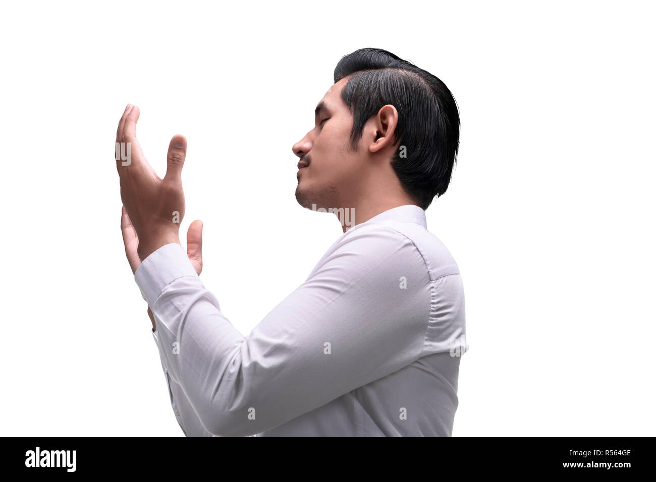 Young asian muslim man raising hand and praying Stock Photo - Alamy