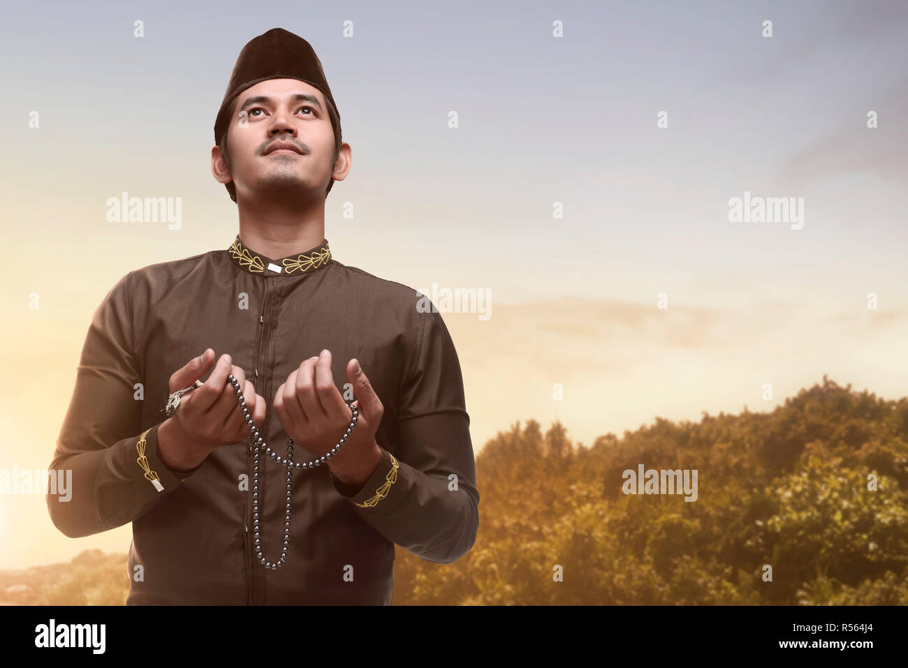 Handsome asian muslim man holding prayer beads and praying Stock Photo ...