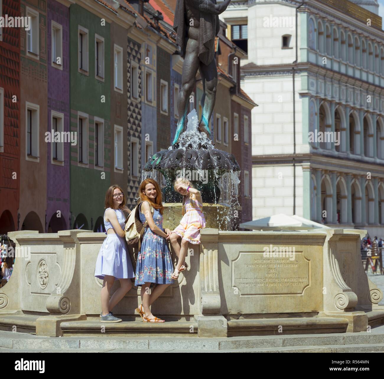 Happy family - mom and two daughters on a square Rynek of polish city ...