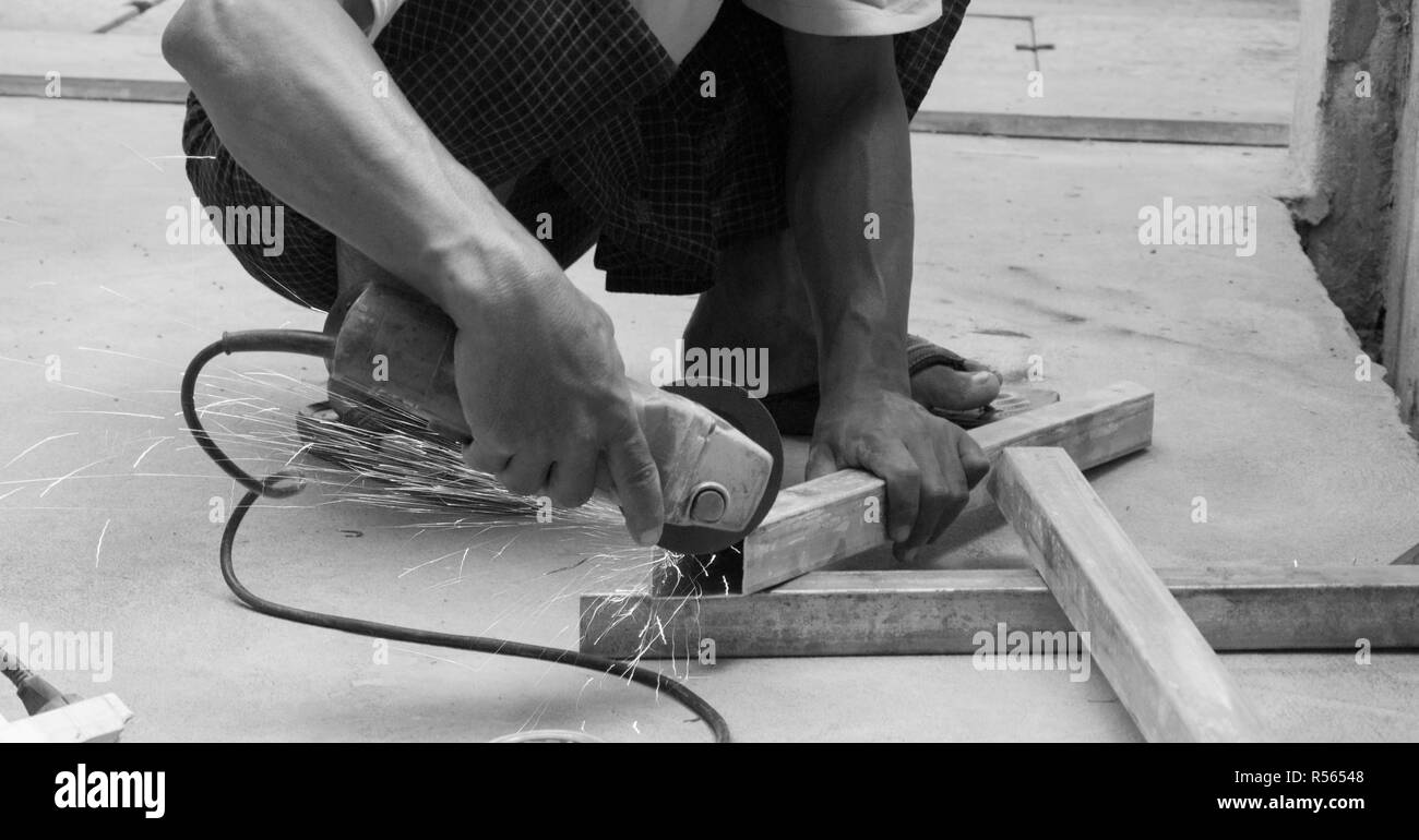 WORKER CUTTING STEEL WITH ELECTRIC WHEEL GRINDER Stock Photo - Alamy
