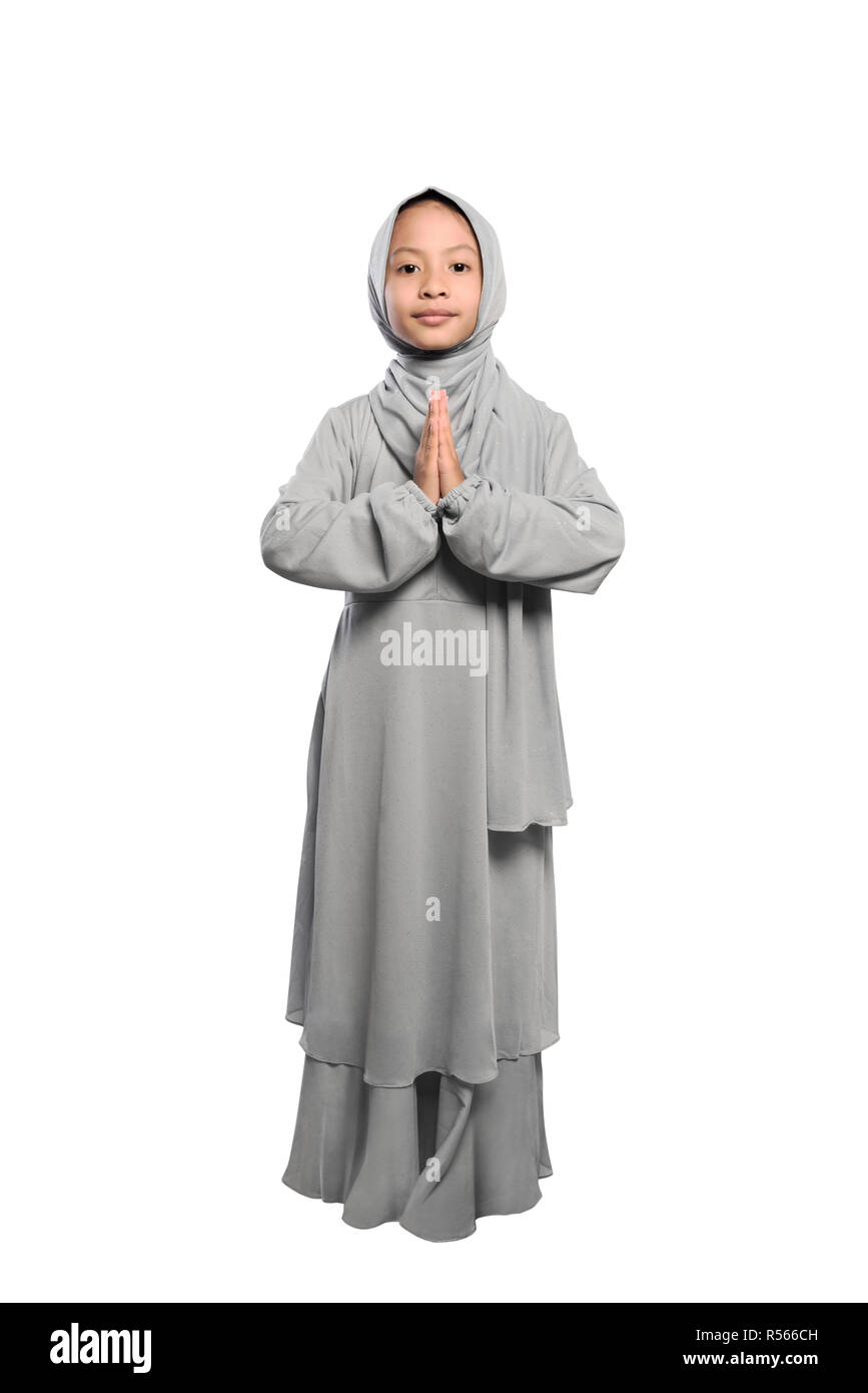 Smiling asian muslim kid with traditional dress standing Stock Photo ...