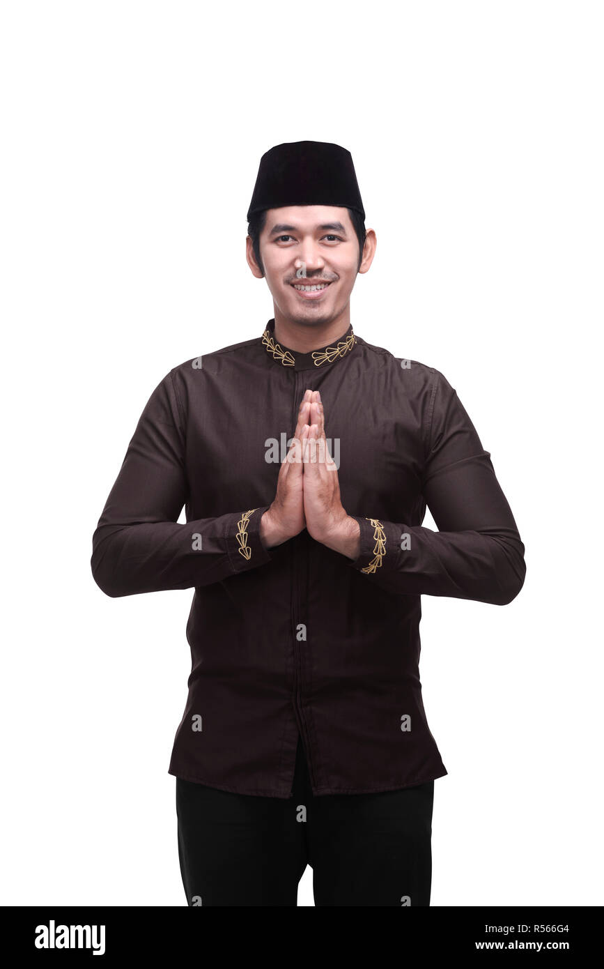 Smiling asian muslim man standing and praying Stock Photo - Alamy