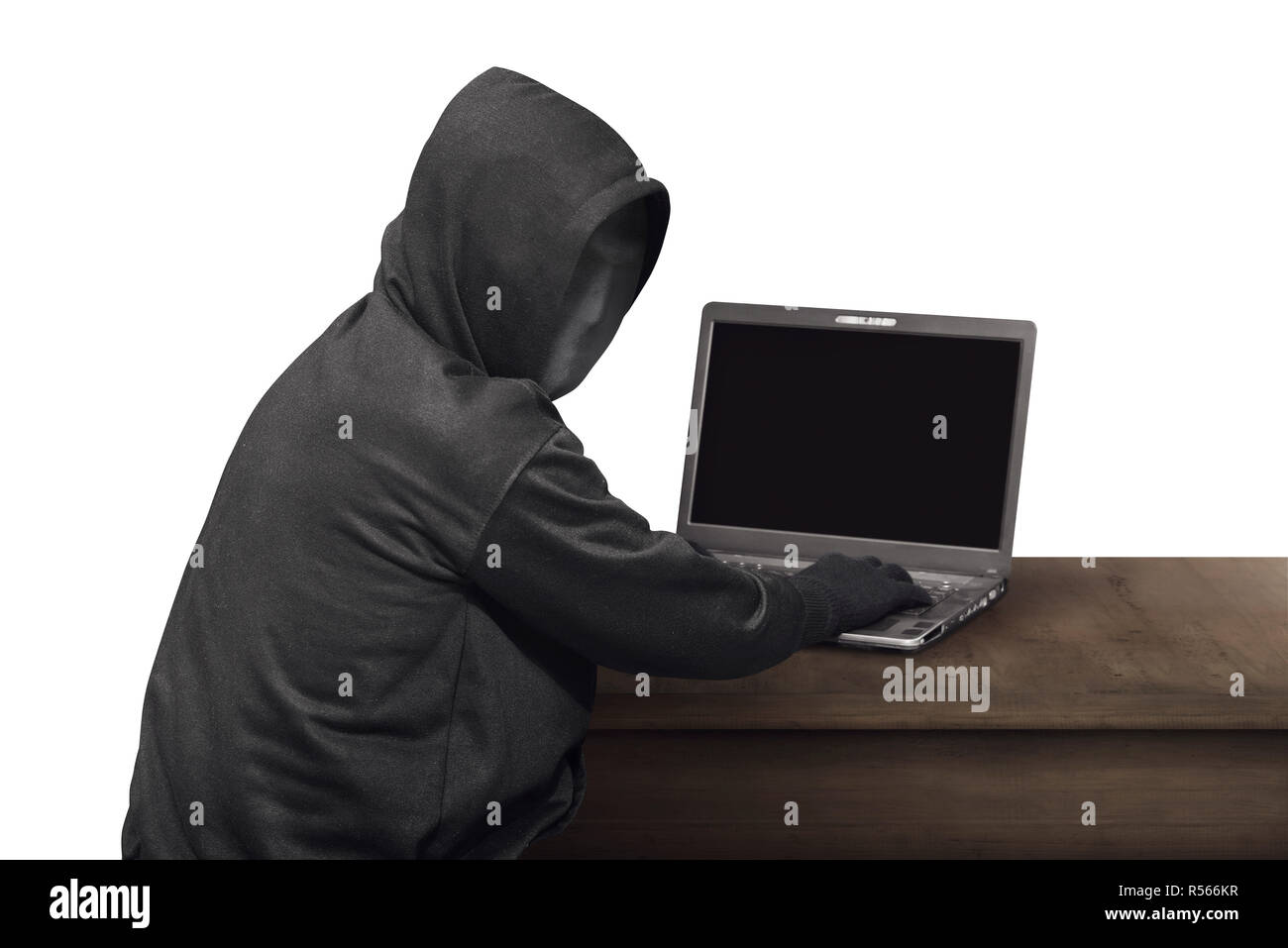 Portrait of hacker man with mask looking back while typing laptop on ...