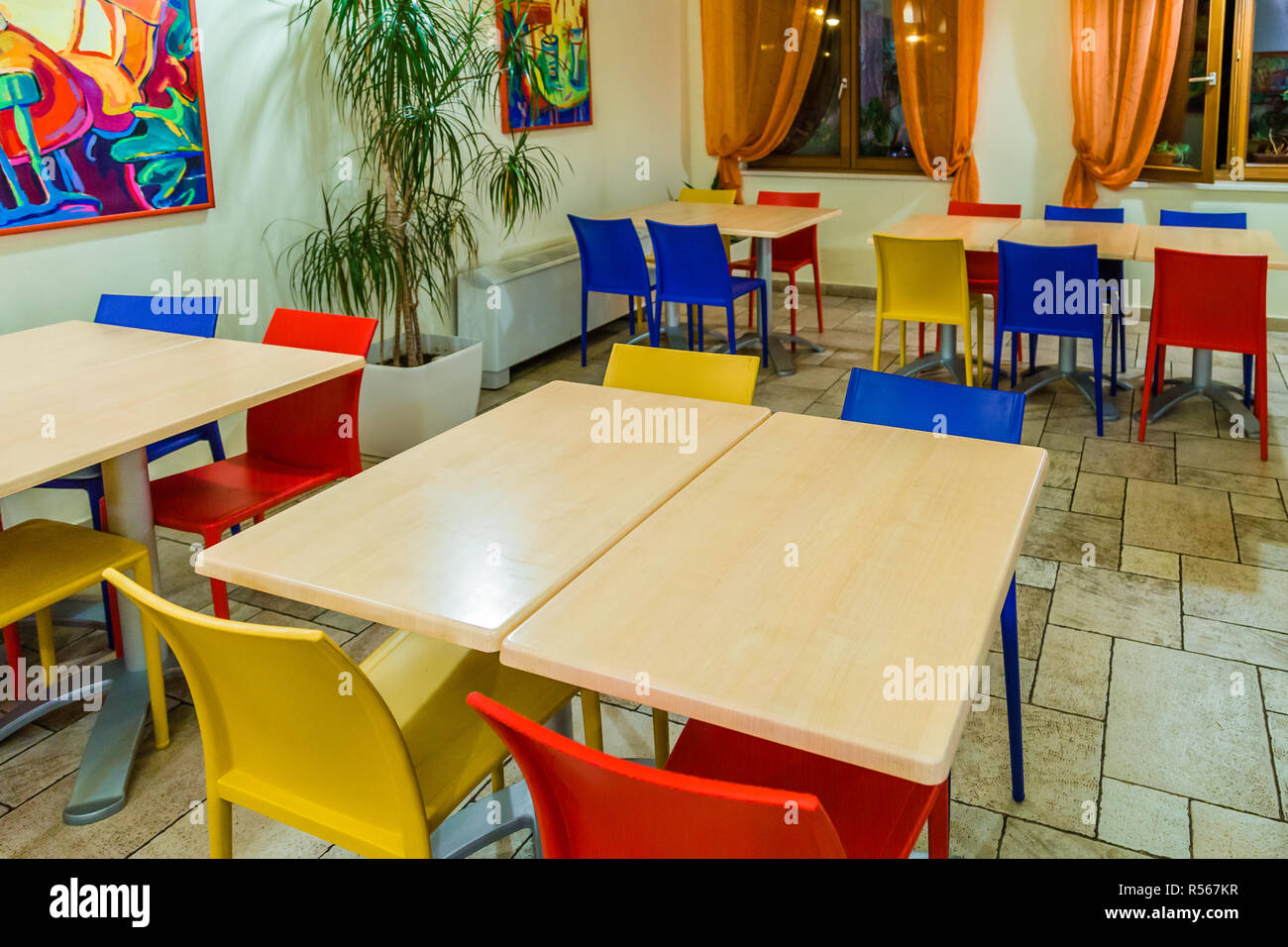 colorful chairs and table in restaurant Stock Photo - Alamy