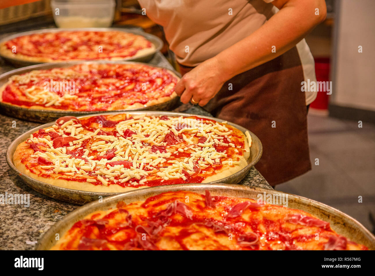 pizza maker at work preparing variety of pizzas Stock Photo - Alamy