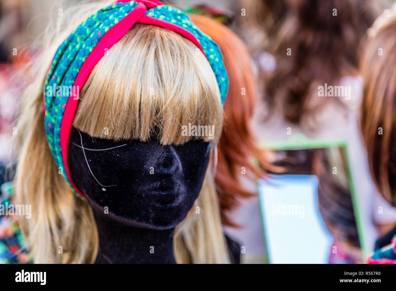 Blond wig on blue dummy Stock Photo - Alamy