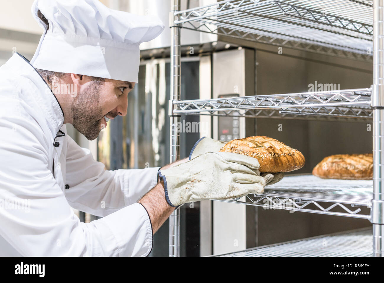Man taking baked bread from hi-res stock photography and images - Alamy