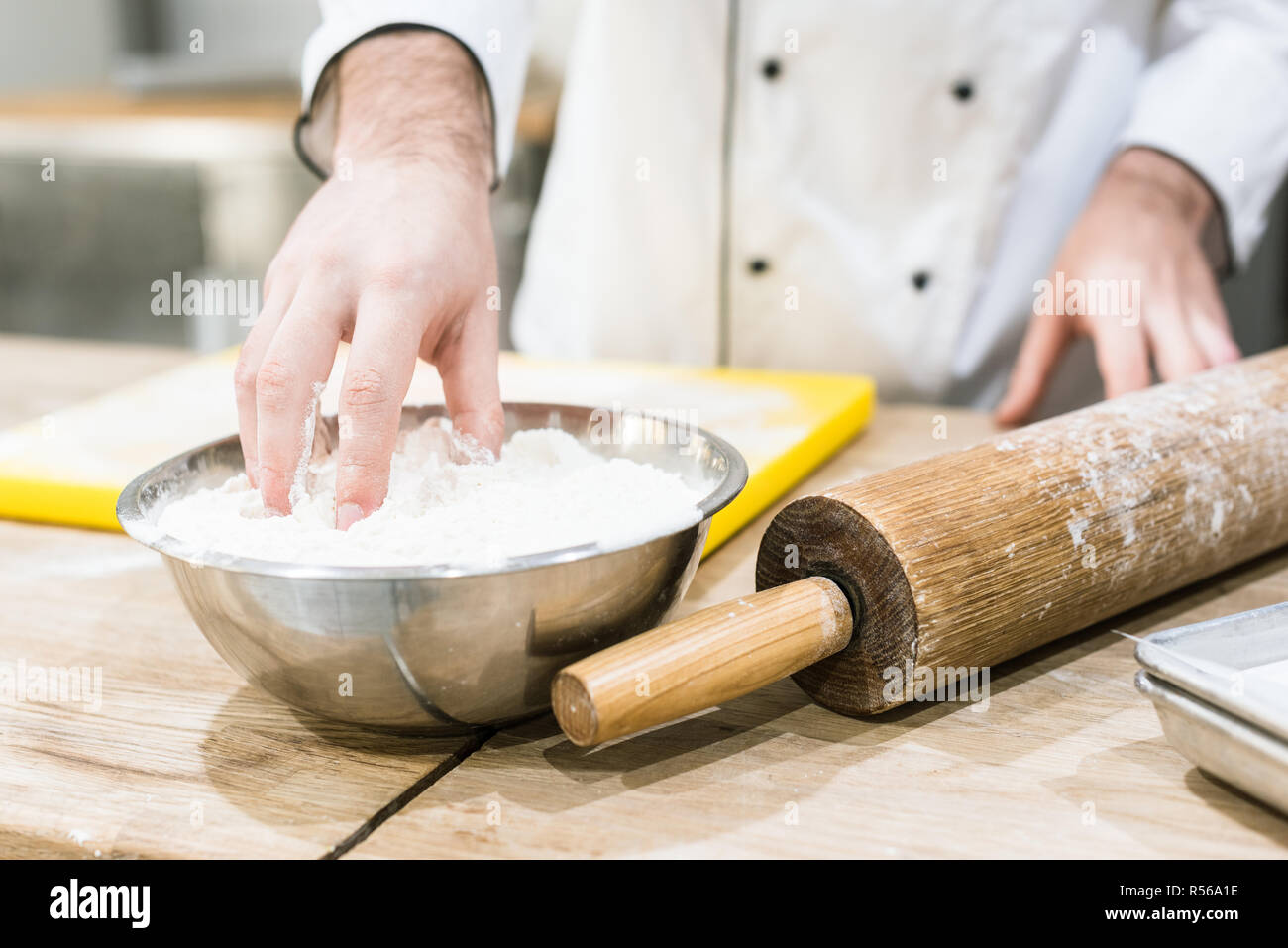 close up of baker hands with dough in metal bowl in bakehouse Stock ...
