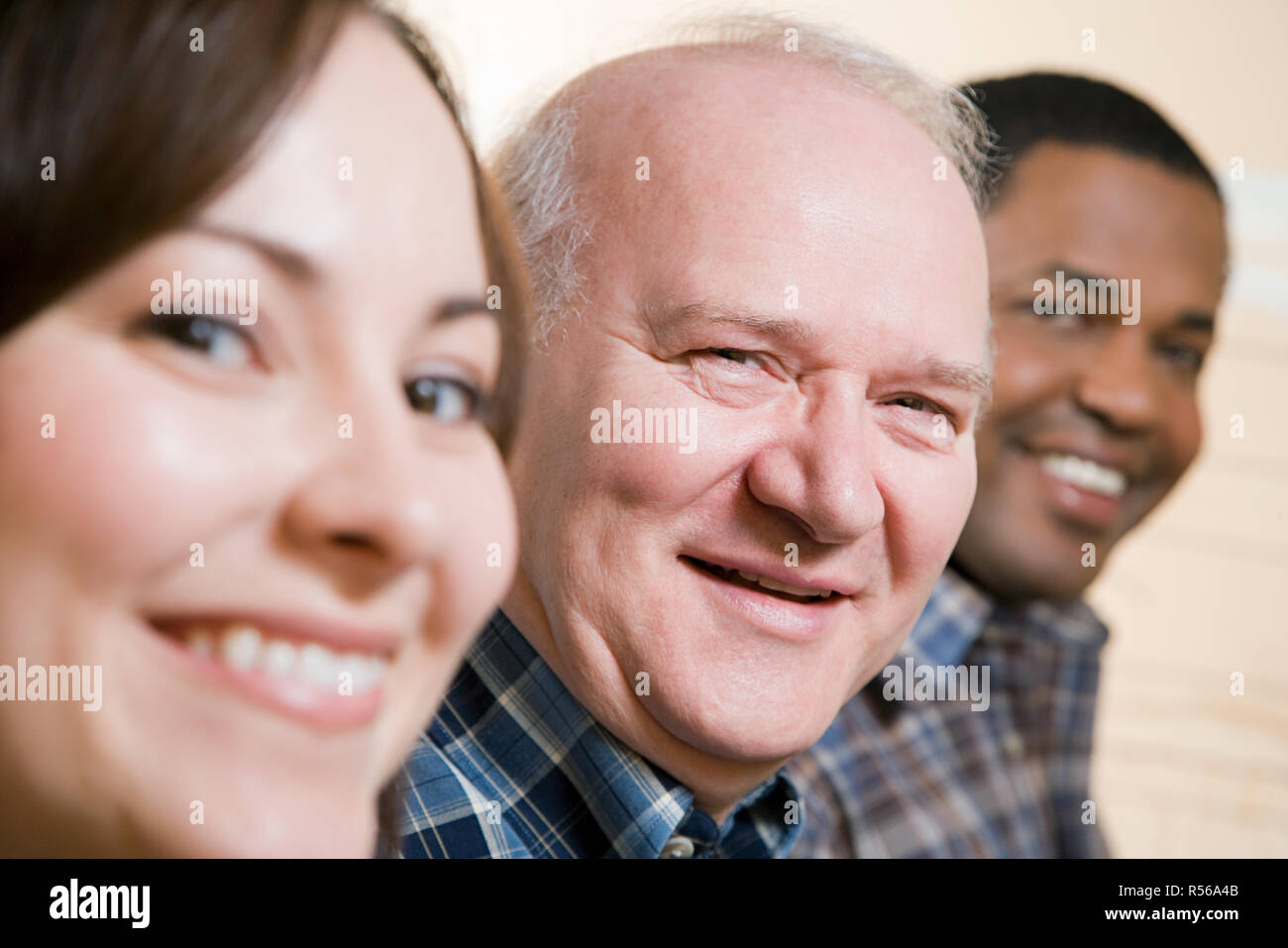 Three people smiling Stock Photo - Alamy