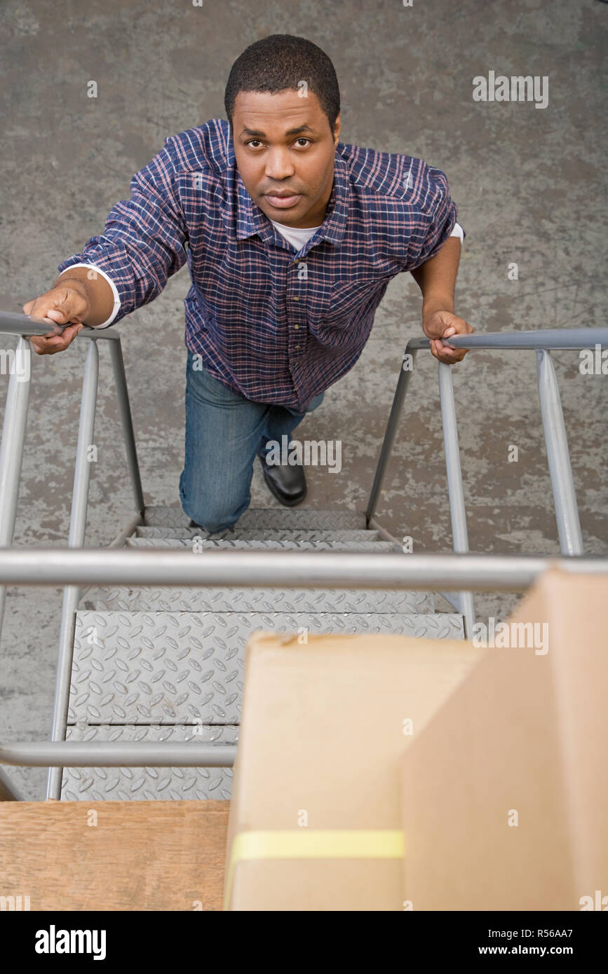 Man climbing steps Stock Photo - Alamy