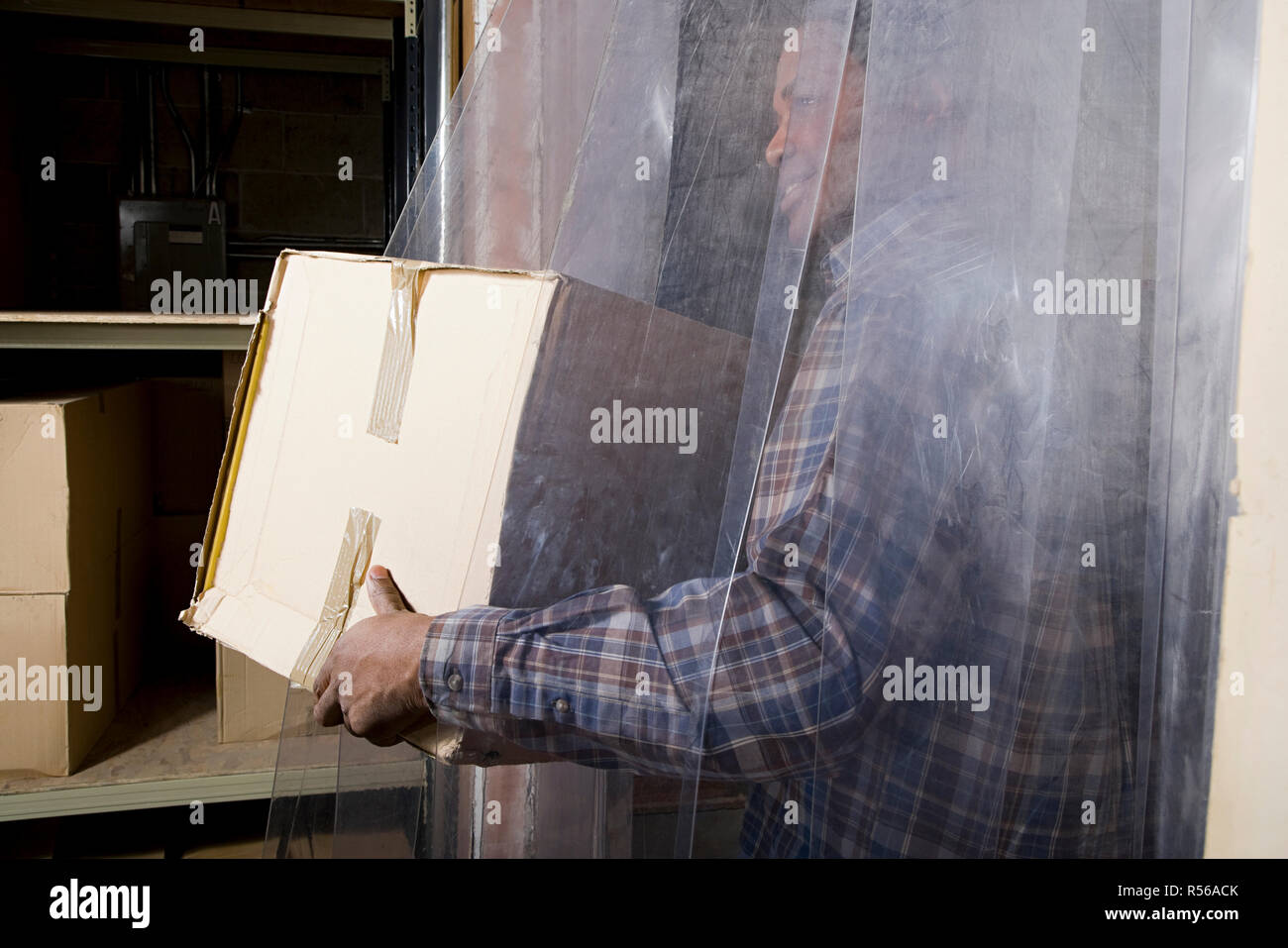 Man walking holding small box hi-res stock photography and images - Alamy